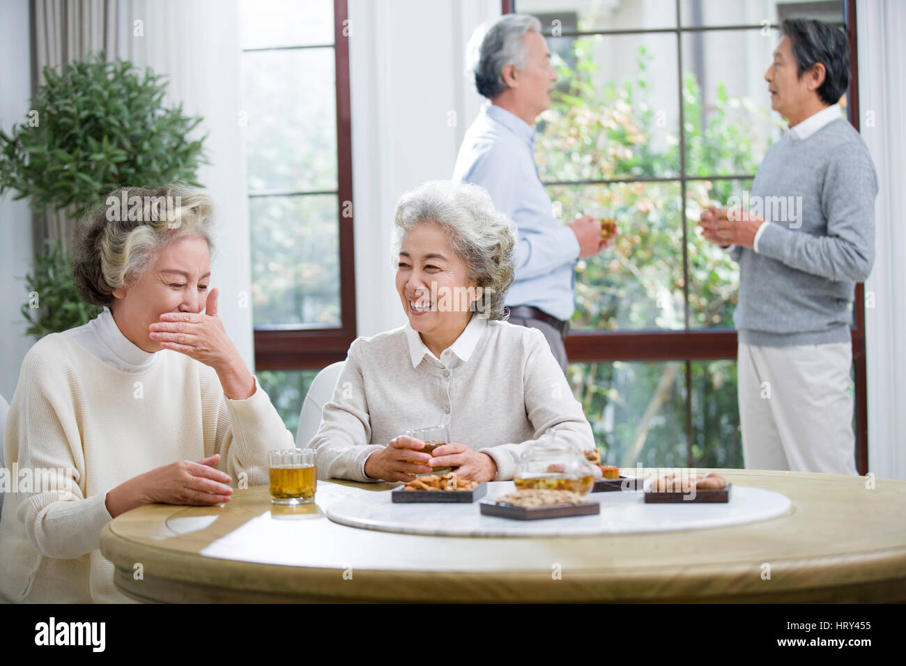 Happy senior friends talking and drinking tea Stock Photo - Alamy
