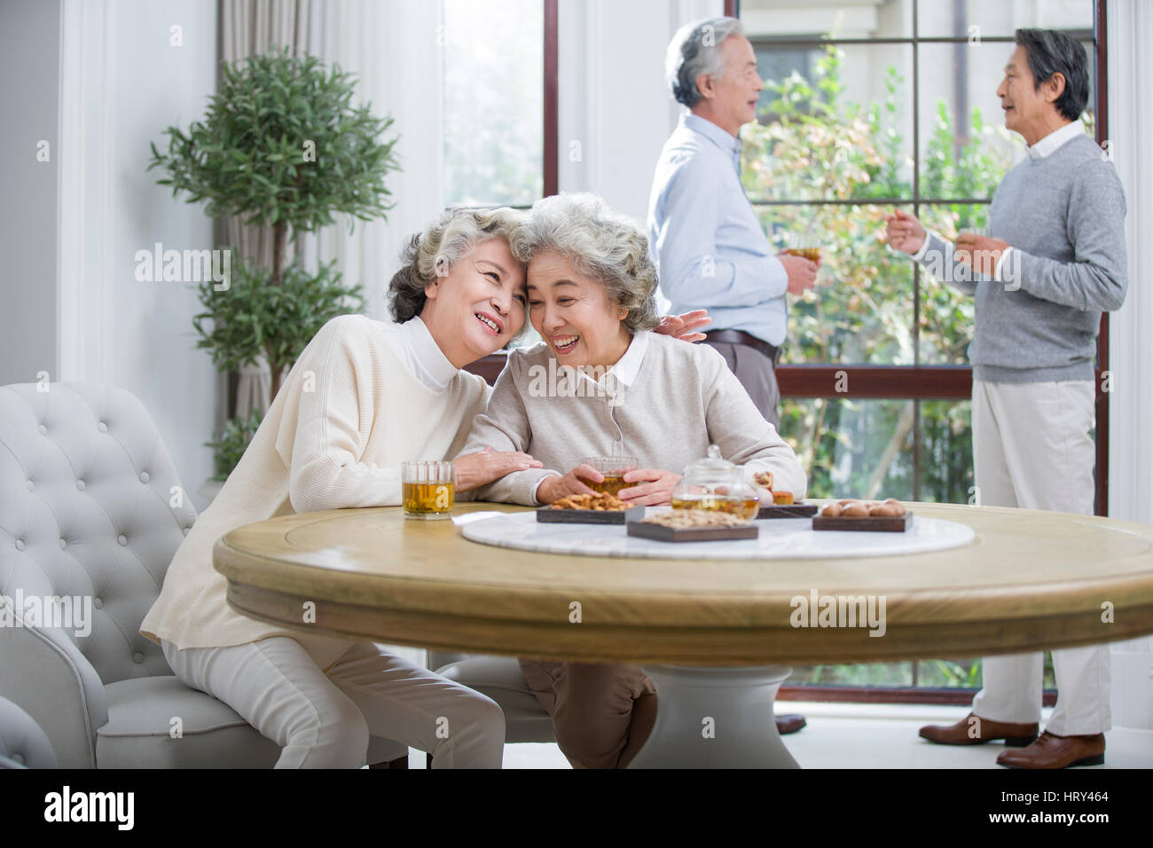 Happy senior friends talking and drinking tea Stock Photo - Alamy