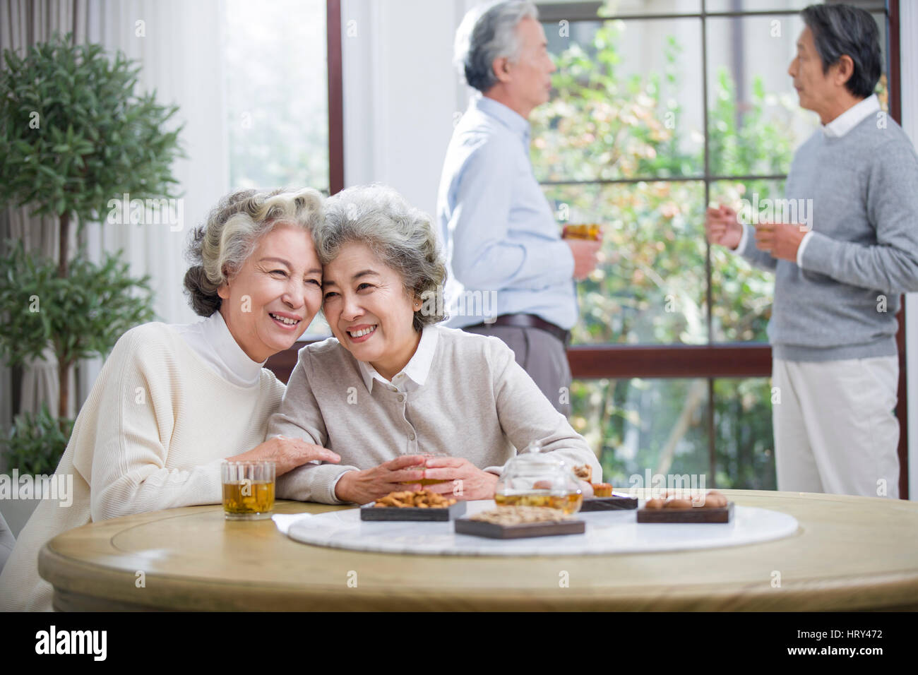 Happy senior friends talking and drinking tea Stock Photo - Alamy