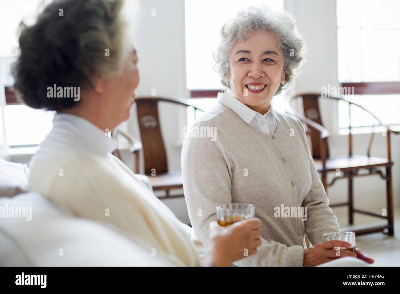 Happy senior friends talking and drinking tea Stock Photo - Alamy