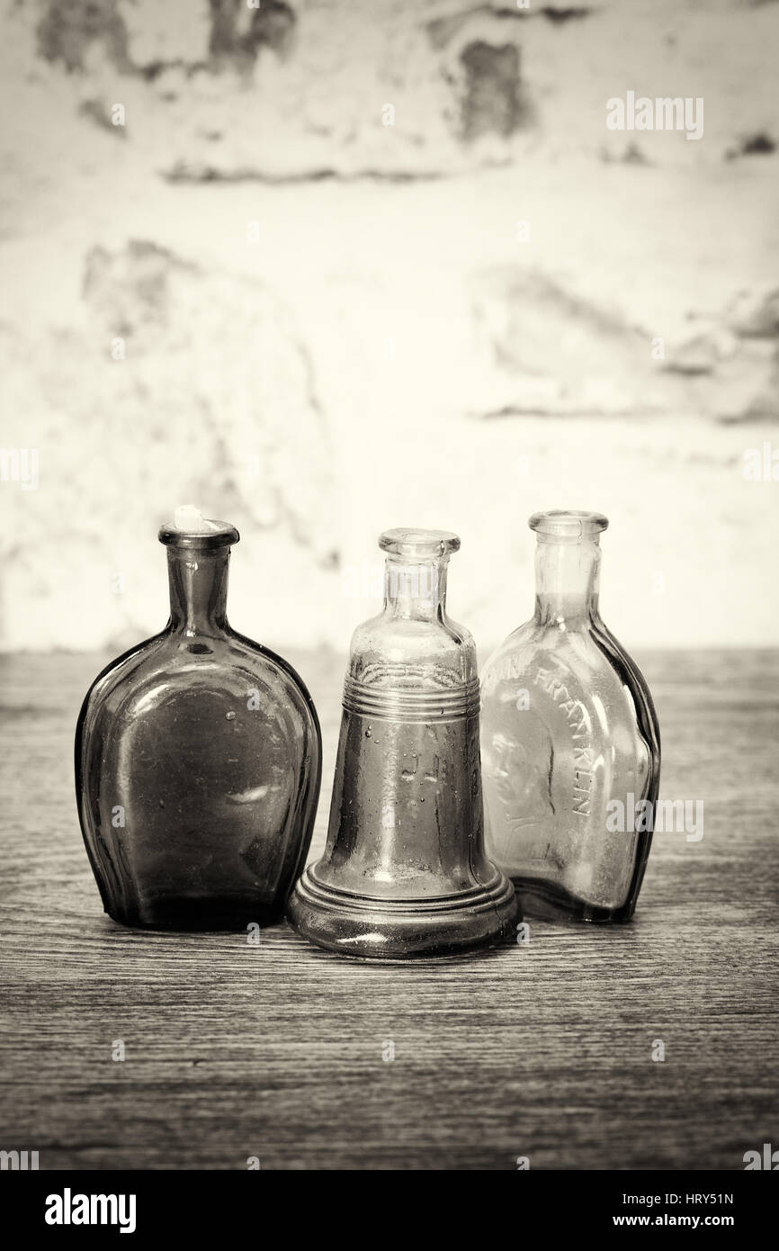 Selection of coloured glass bottles on a rustic background Stock Photo ...