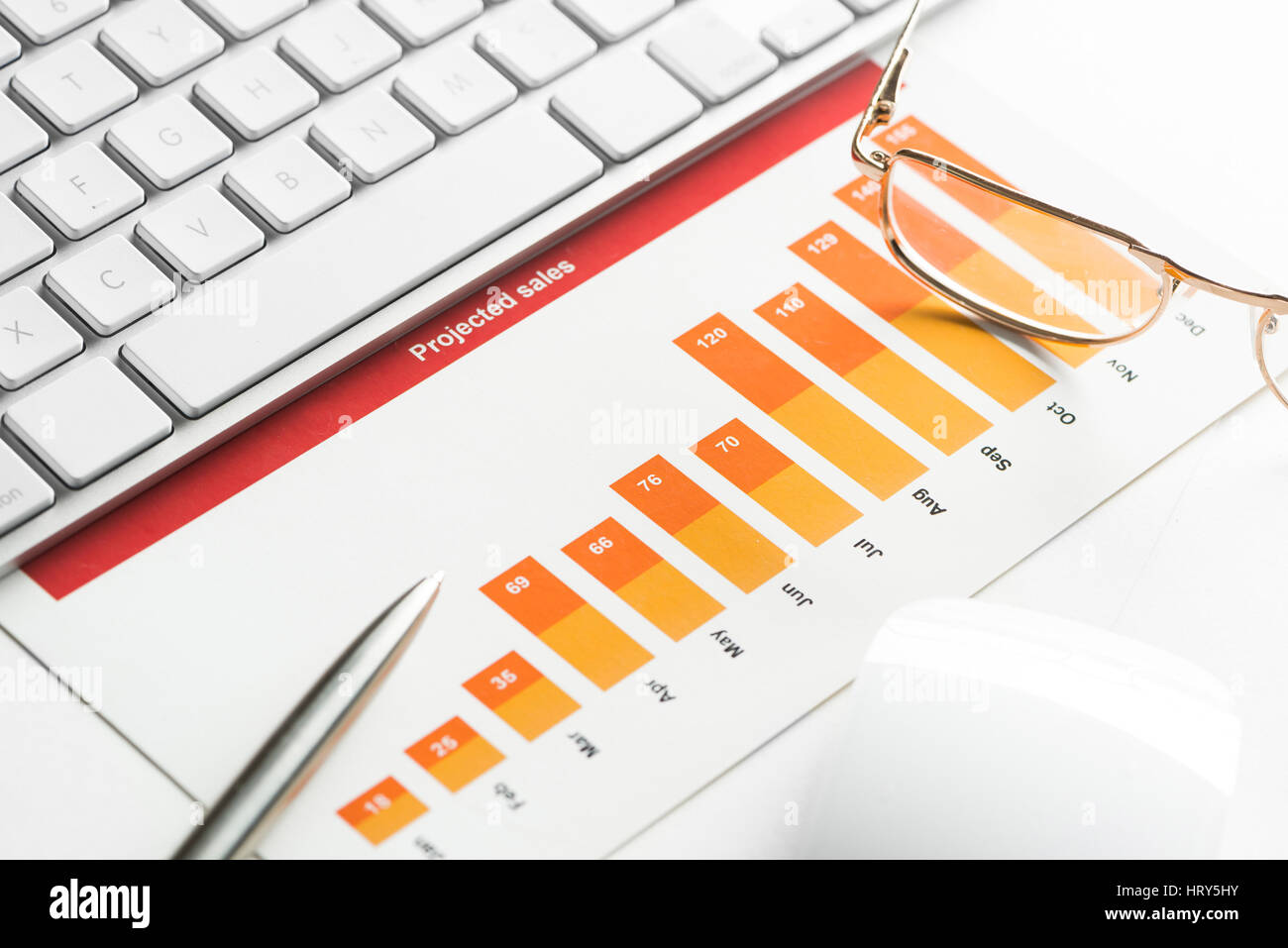 Business workplace with keyboard mouse and papers with graphs and ...