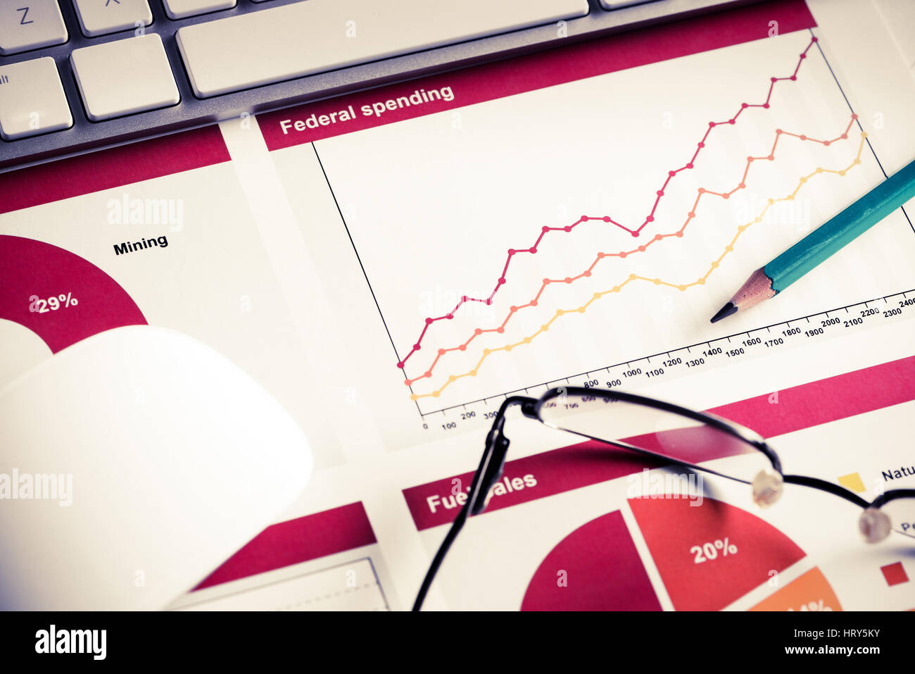 Business workplace with keyboard mouse and papers with graphs and ...