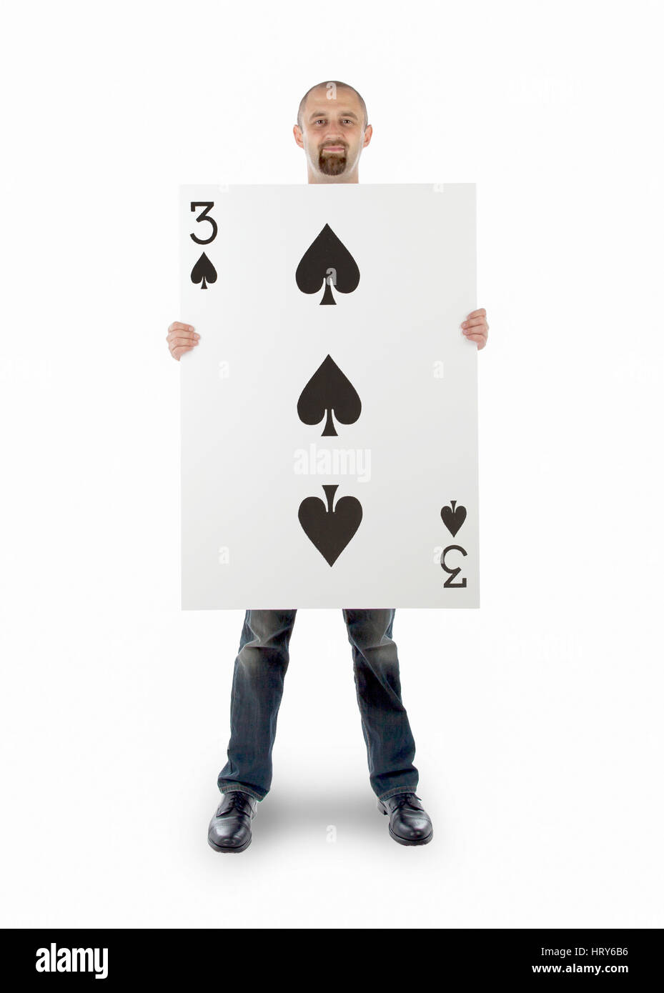 Businessman with large playing card - Three of spades Stock Photo - Alamy