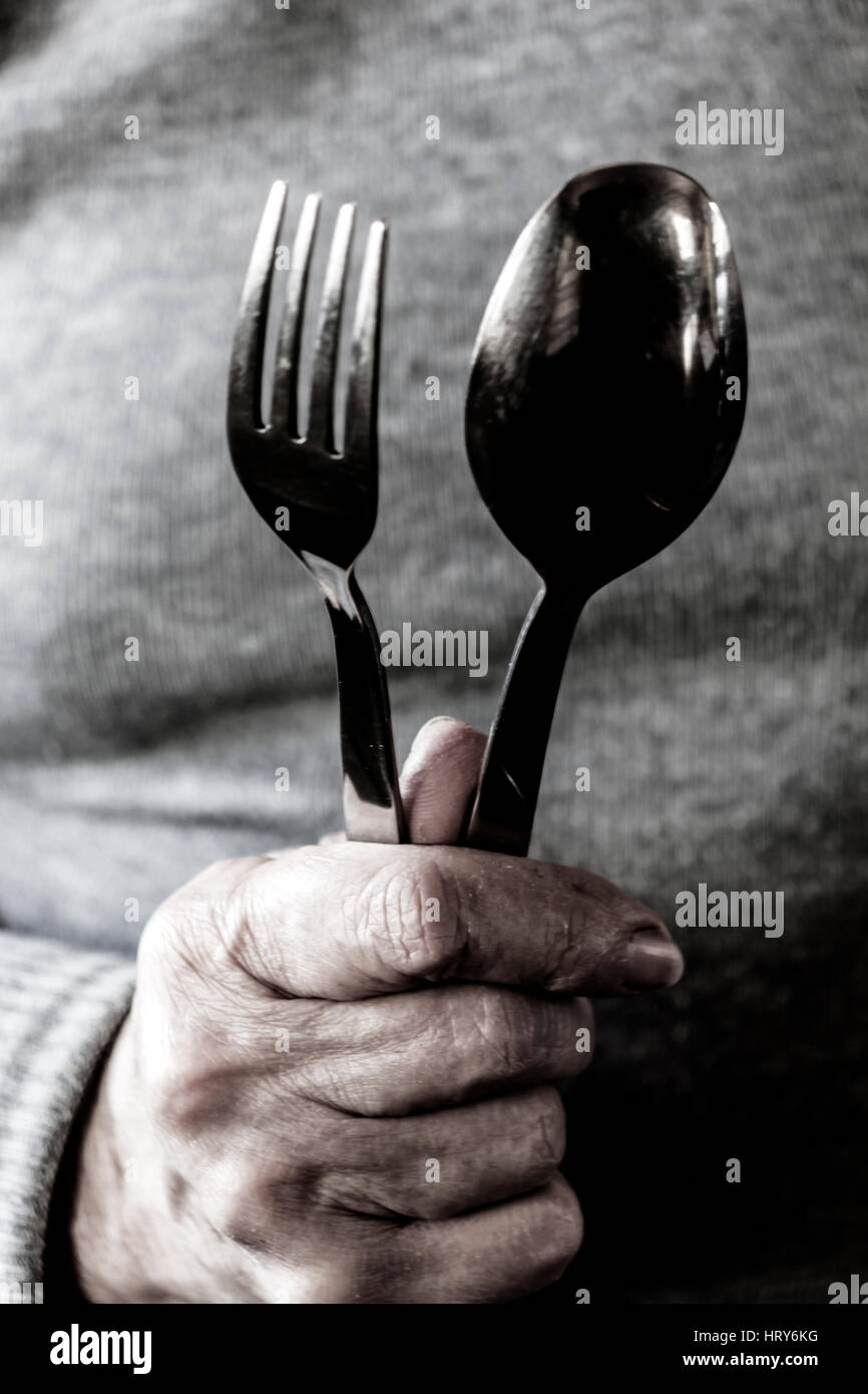 hand holding fork and spoon Stock Photo - Alamy