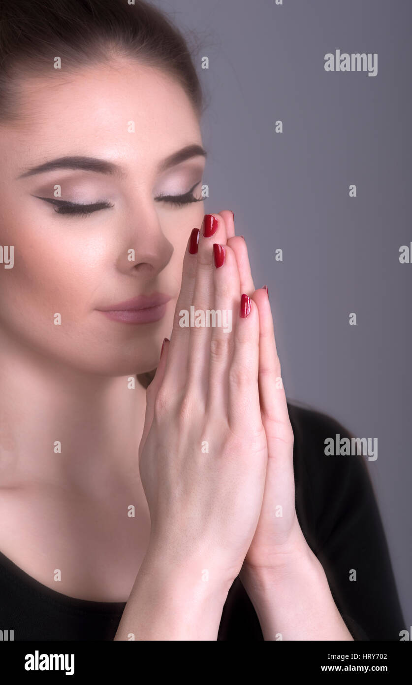 Women holding hands praying together hi-res stock photography and ...