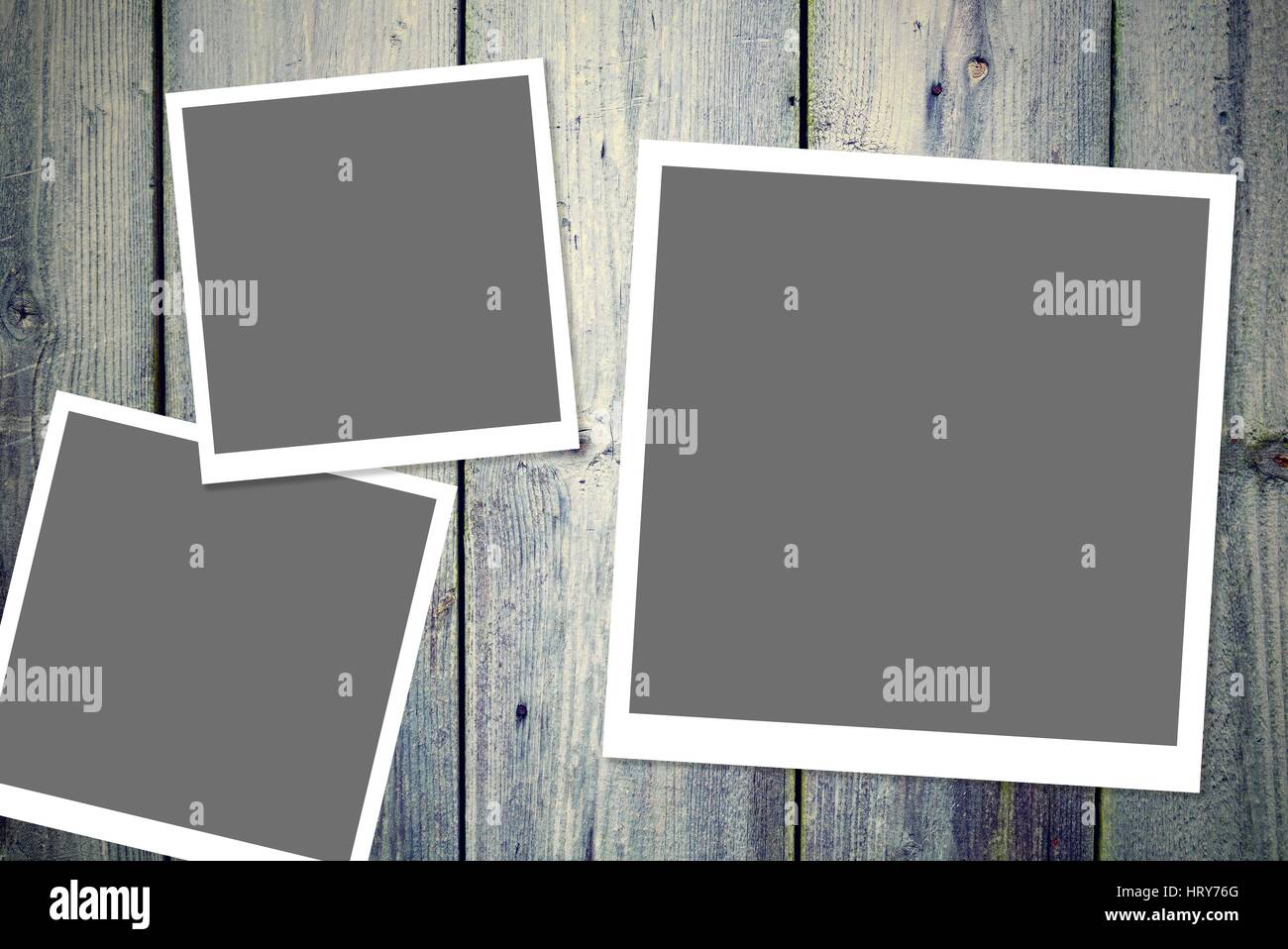 Three instant vintage white photo frames with blank gray space placed ...