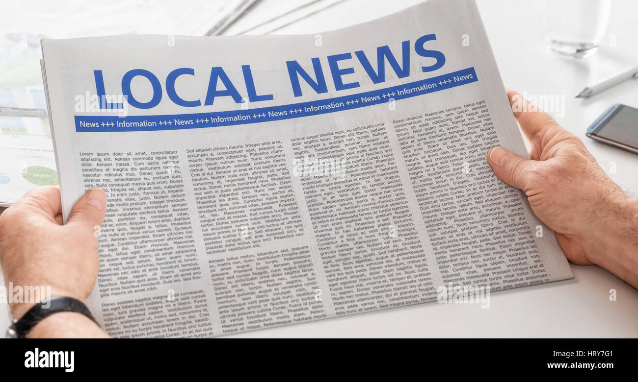 Man reading newspaper with the headline Local News Stock Photo - Alamy