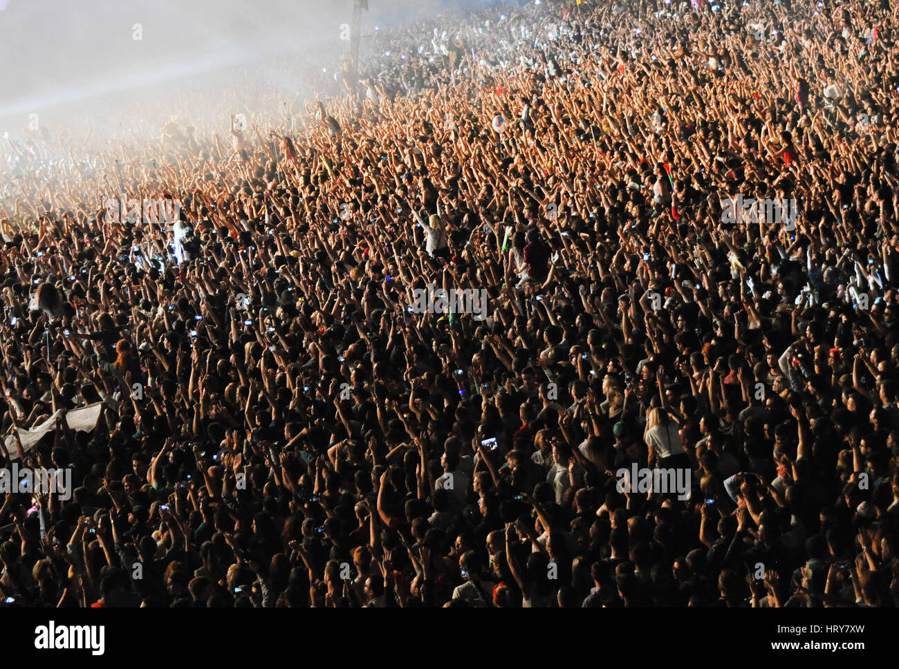 CLUJ NAPOCA, ROMANIA – JULY 31, 2015: Crowd of party people raising ...