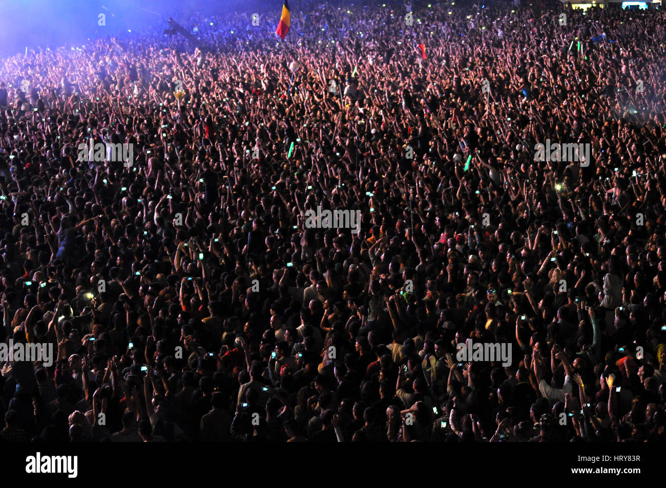 CLUJ NAPOCA, ROMANIA – JULY 31, 2015: Crowd of party people raising ...