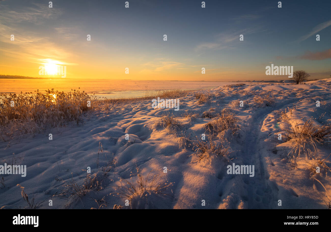 Winter landscape with snow, sea, ocean, ice, blue sky, road with snow ...