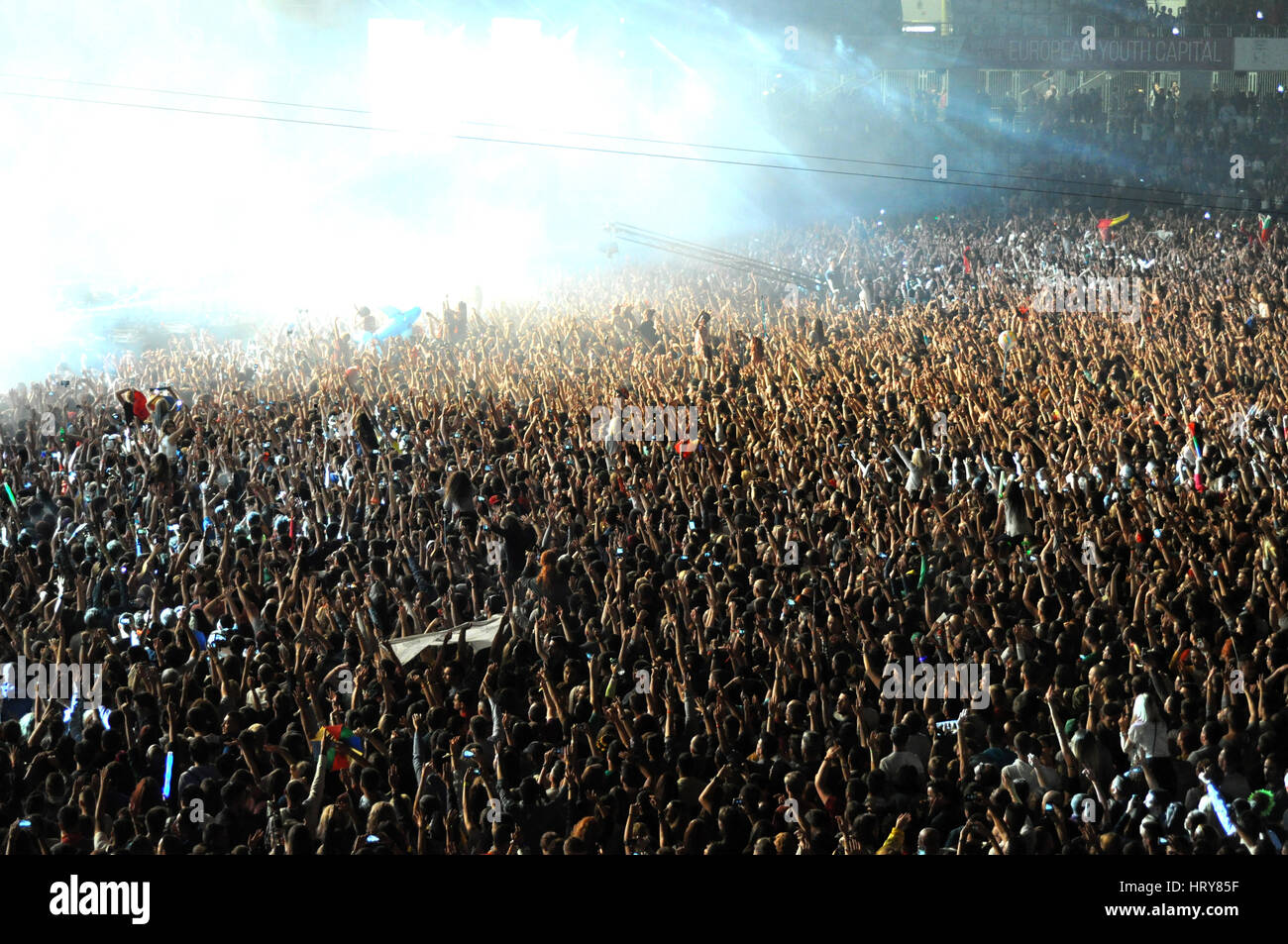 CLUJ NAPOCA, ROMANIA – JULY 31, 2015: Crowd of party people raising ...