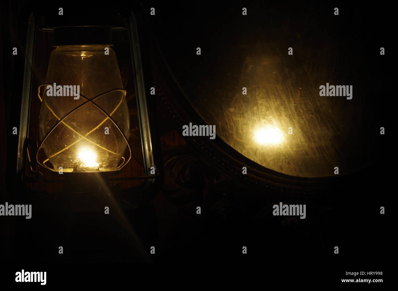 Oil lamp and mirror in the dark Stock Photo - Alamy