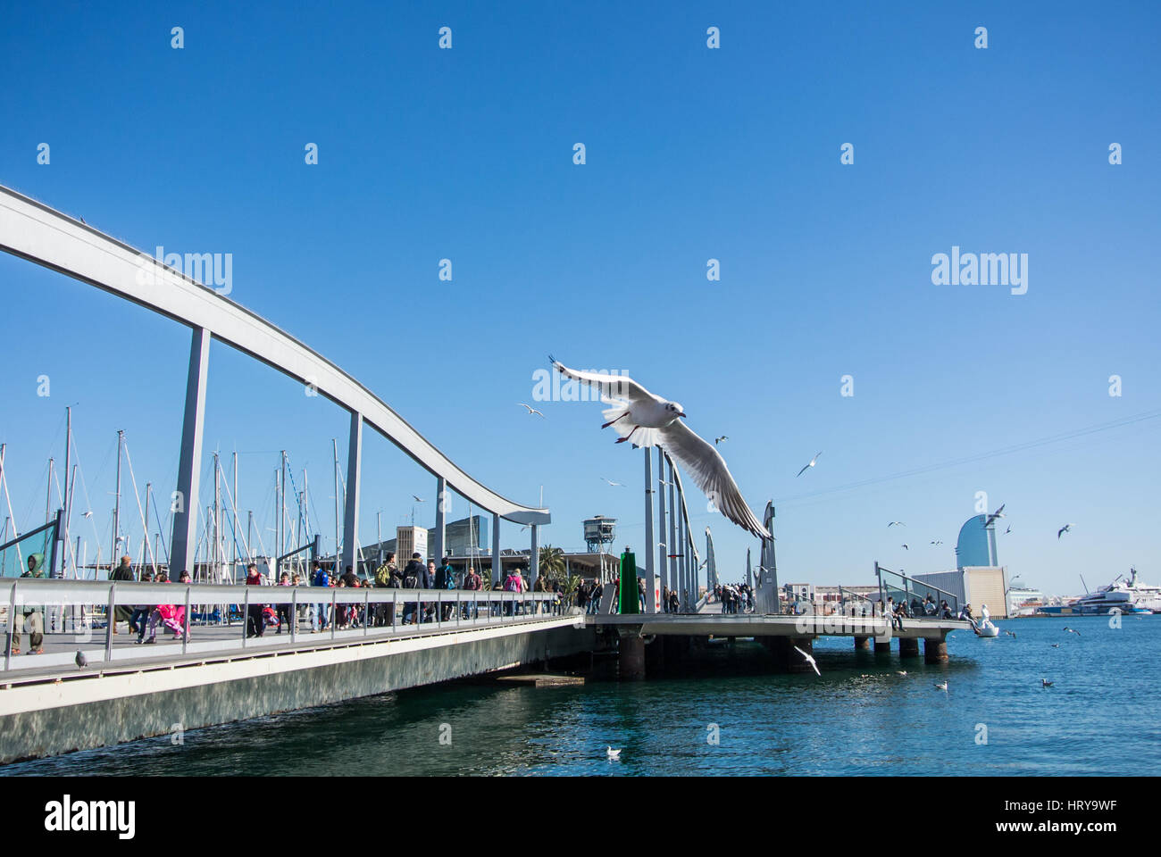 BARCELONA, SPAIN - FEBRUARY 12, 2014: A view to a pier with yachts, an ...