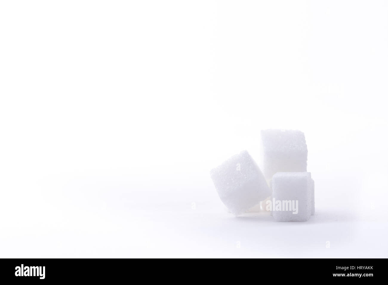 A stack of white sugar cubes, isolated in front of a white background ...