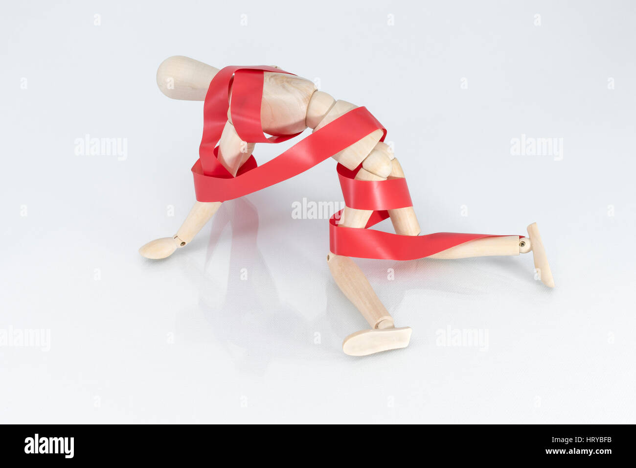 Artists's mannequin wrapped up in red tape - metaphor for meddling ...