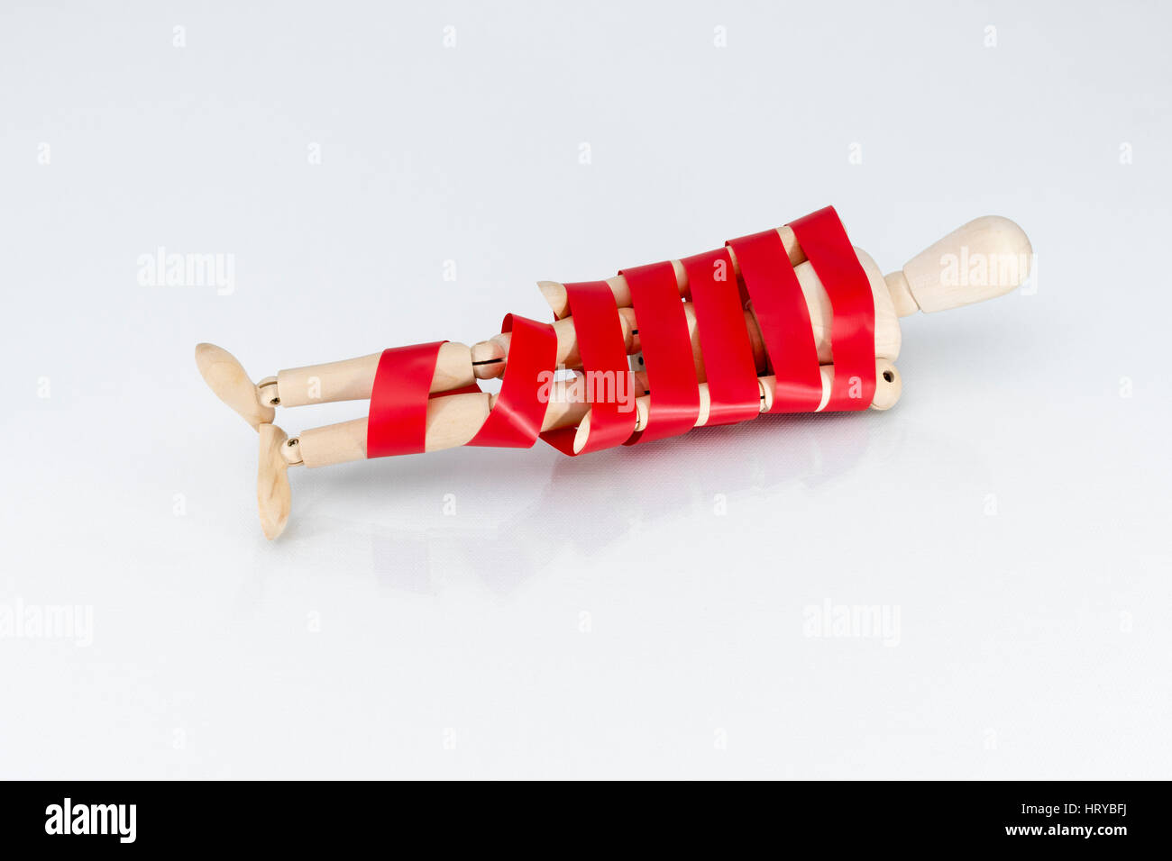 Artists's mannequin wrapped up in red tape - metaphor for meddling ...