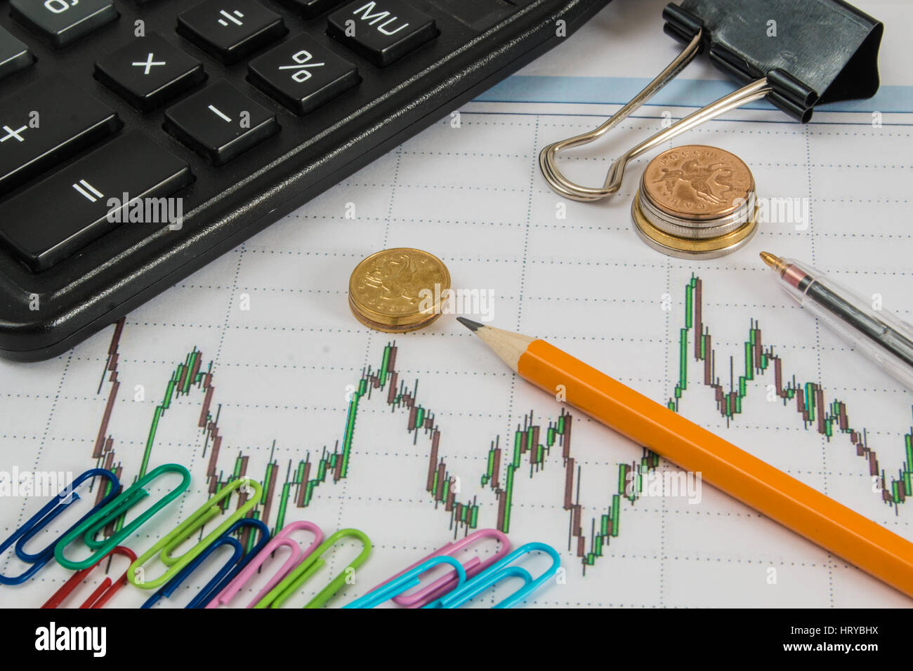 Financial graph on white background with calculator, coins, pens ...