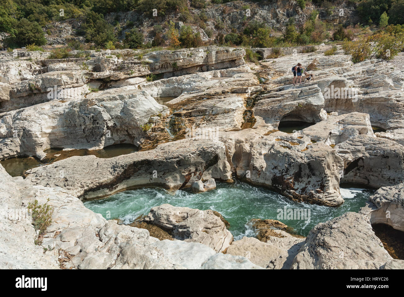 People walking with their dogs along the bank of the river Ceze at ...