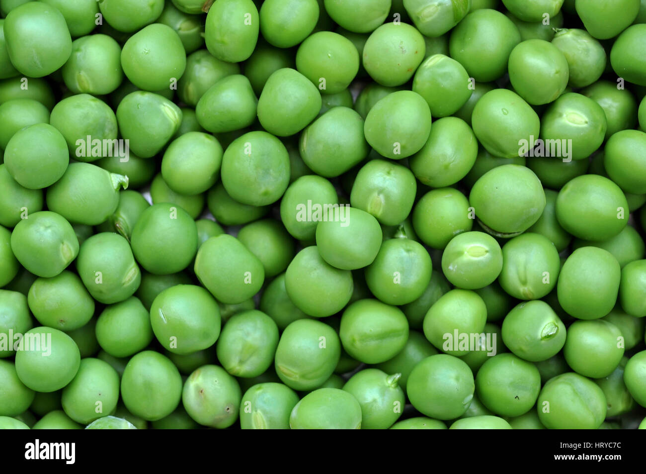 Fresh green peas background texture Stock Photo - Alamy
