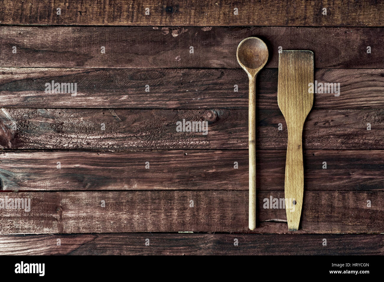 wooden kitchen spatula and a spoon on a brown surface, a top view, an ...