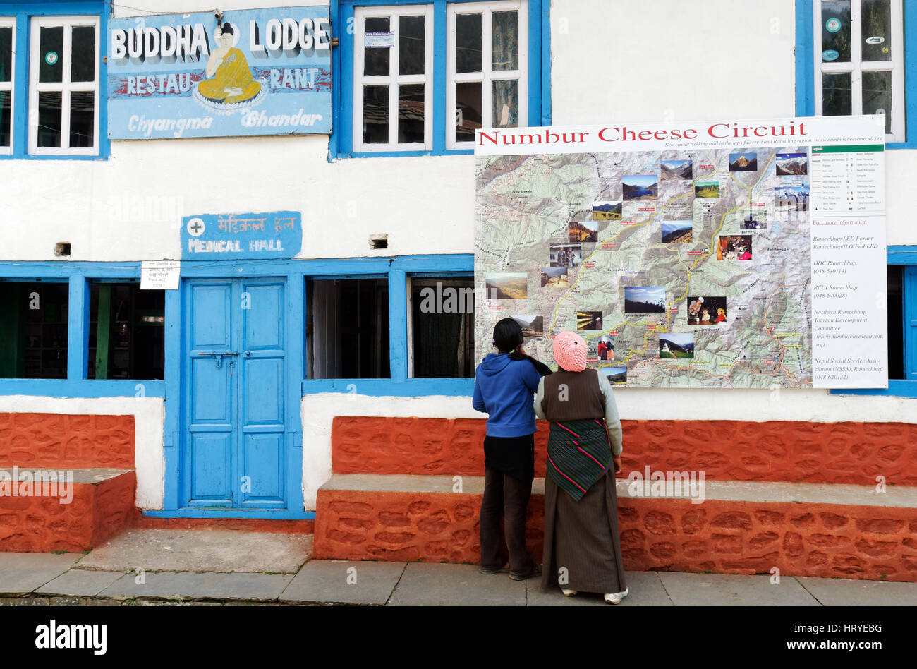 Two people looking at a map of the Numbur Cheese Circuit, a trekking ...
