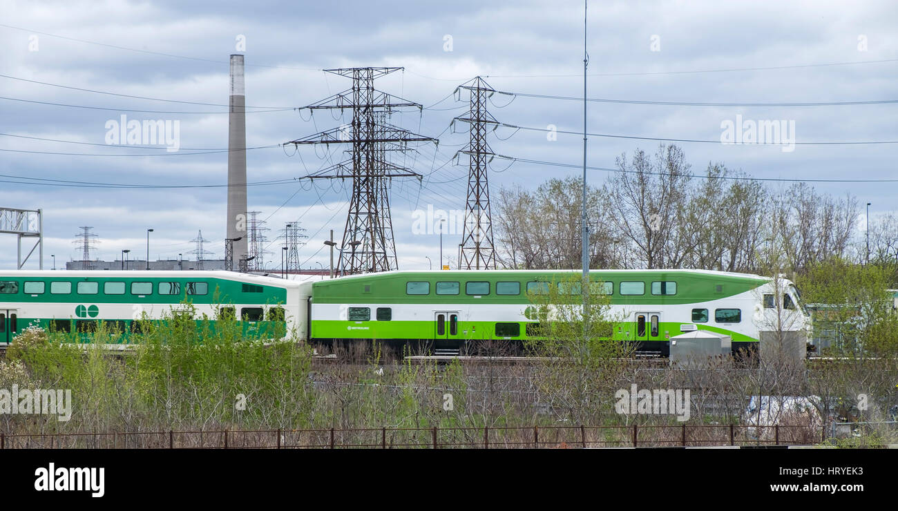 A green GO transit train full of commuters on it's way to downtown ...
