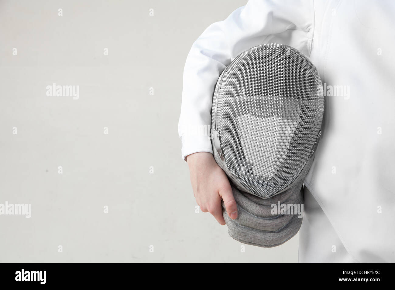 Female fencer wearing hold the fencer maskwhite fencing costume ...