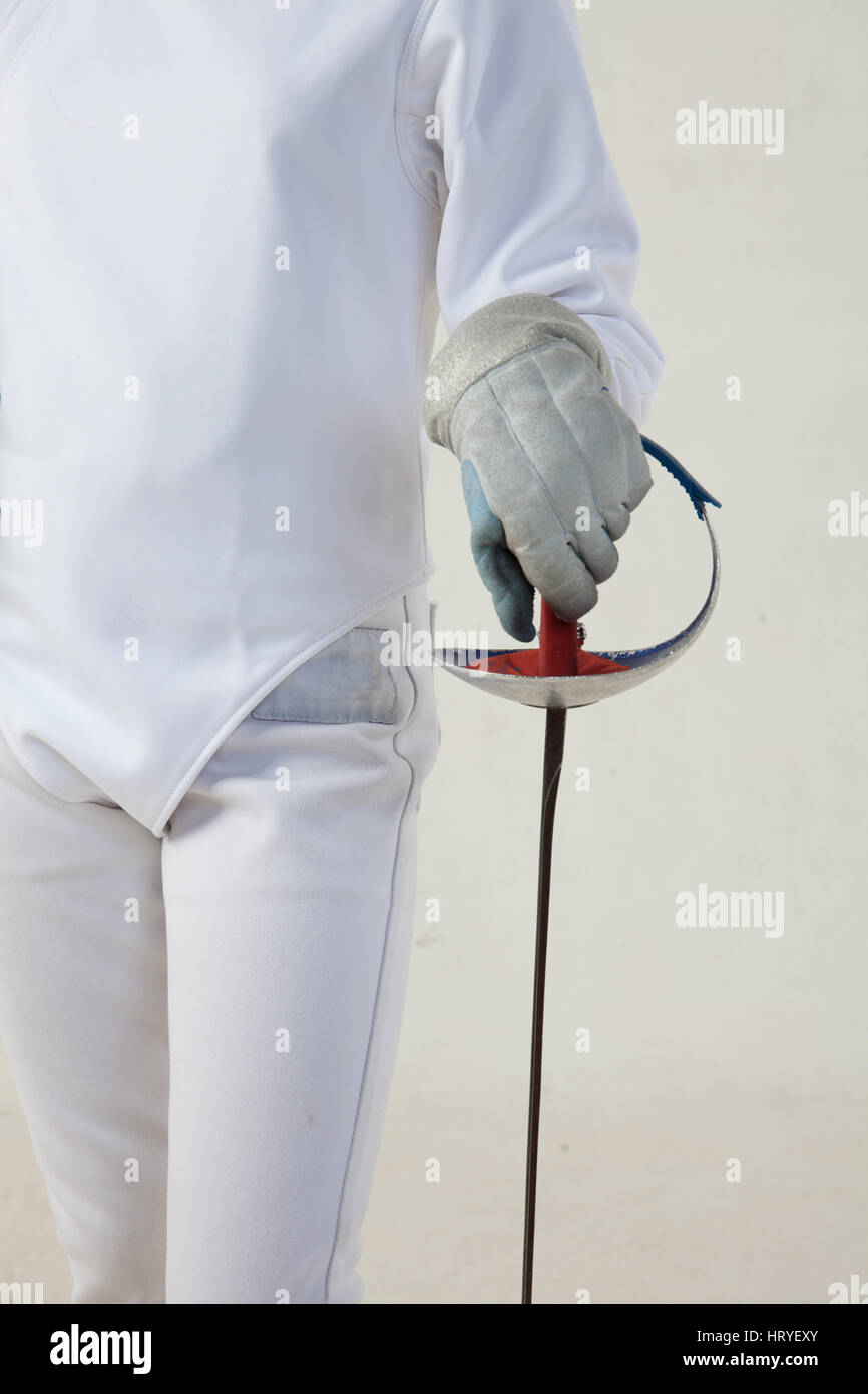 Female fencer hold the epee and wearing white fencing costume isolated ...