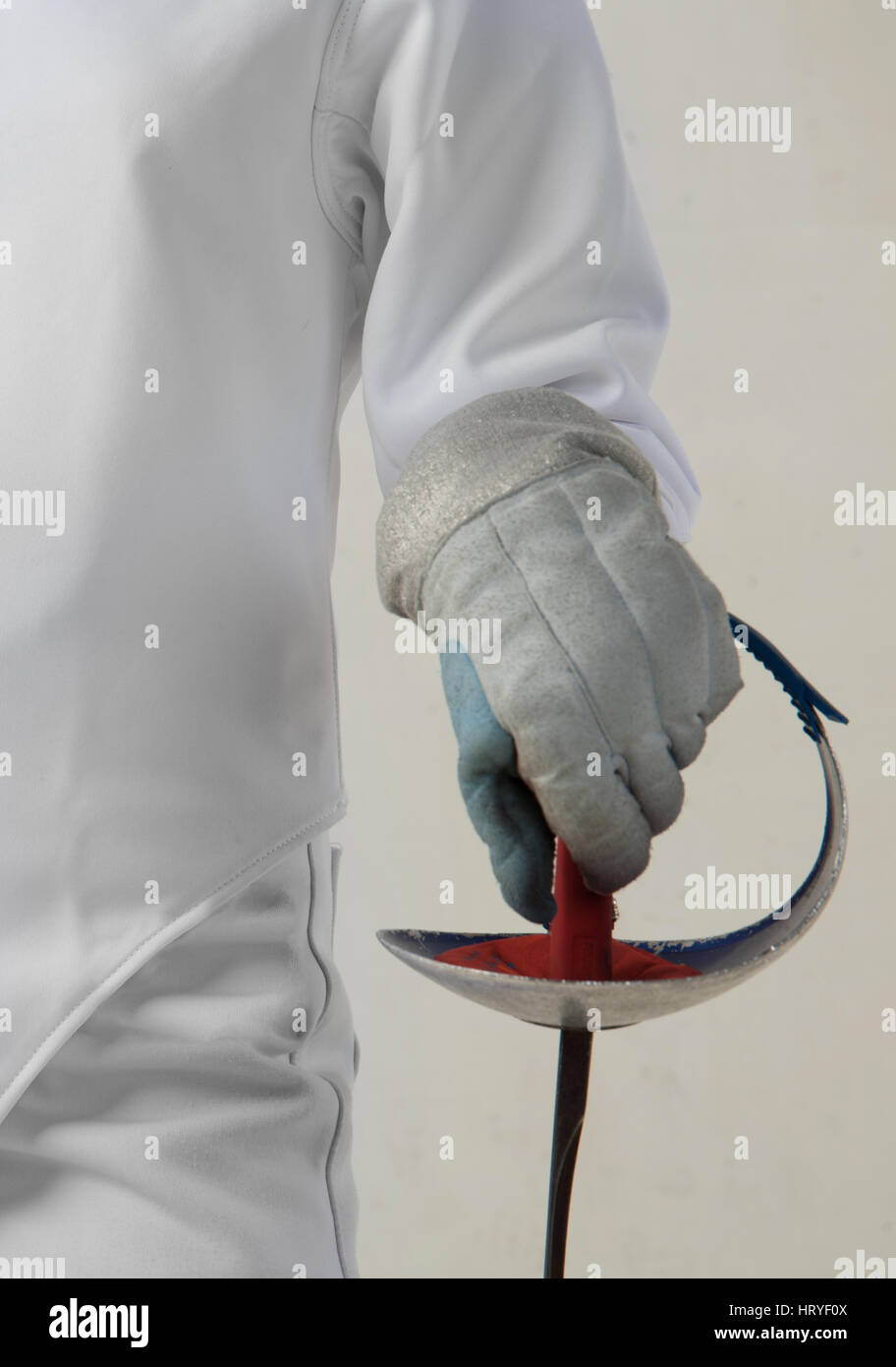 Female fencer hold the epee and wearing white fencing costume isolated ...