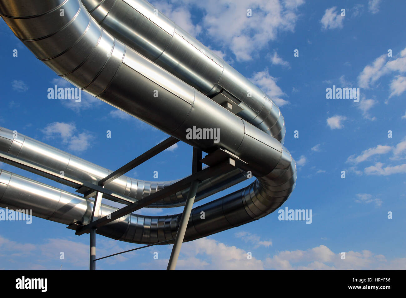 steel pipes under blue sky in industrial zone Stock Photo - Alamy