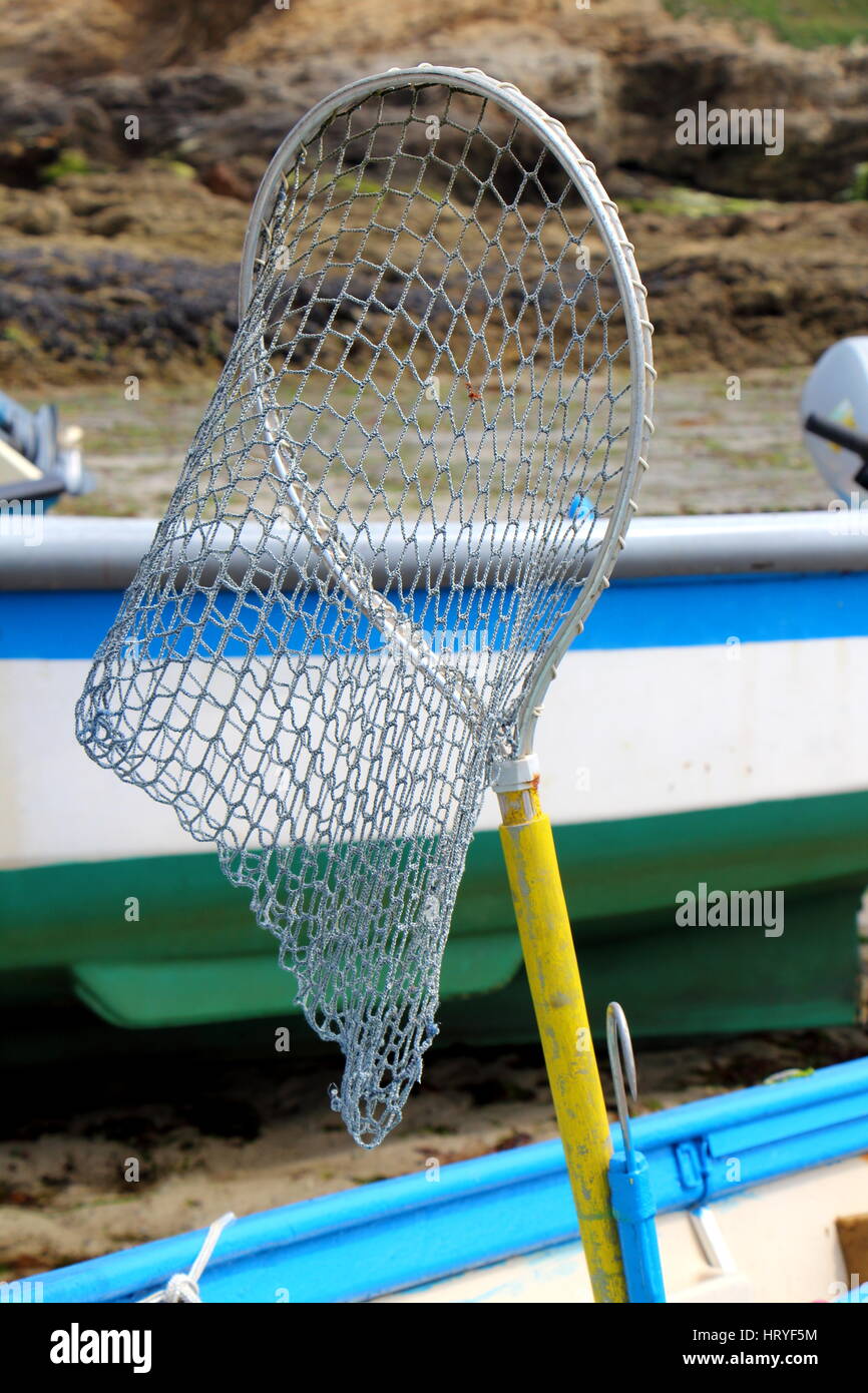 Landing net in a boat Stock Photo - Alamy