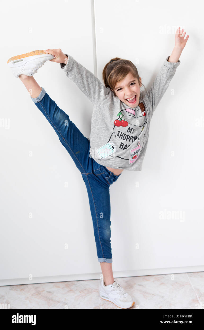 Portrait of a girl with leg raised. Vertical shot with natural light ...