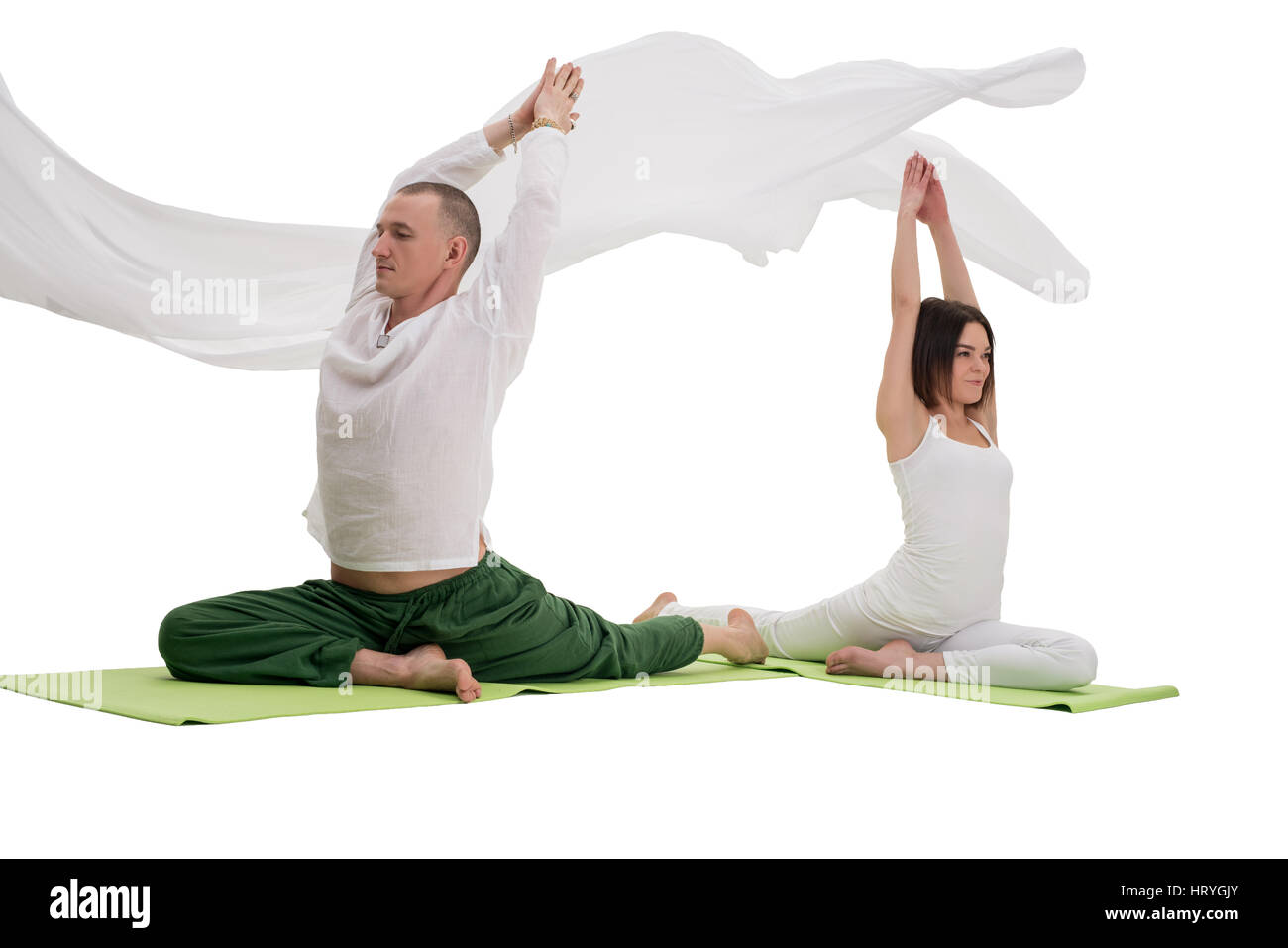 Man and woman doing yoga exercises in studio Stock Photo - Alamy