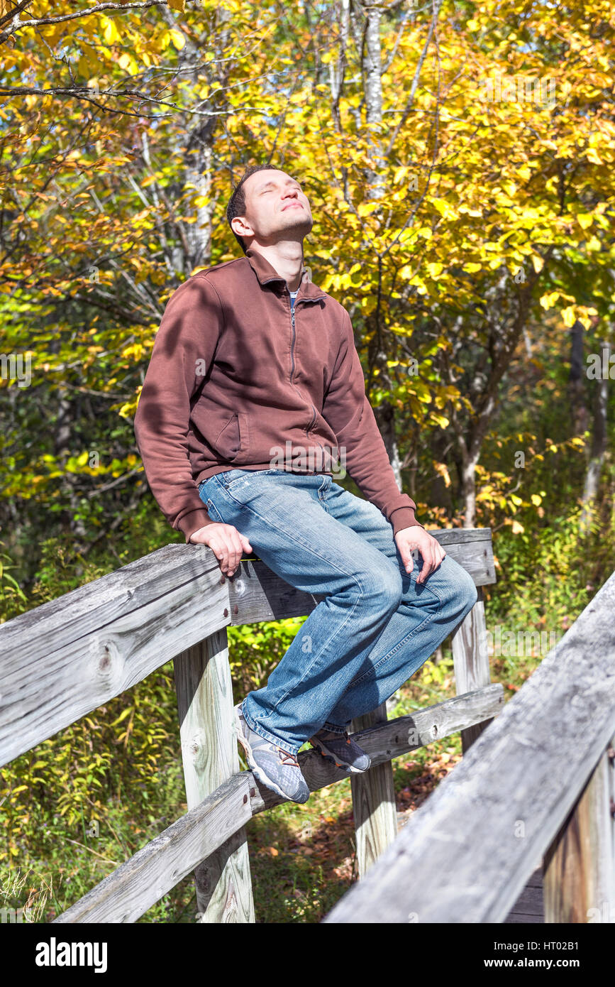 Young man basking in sunlight hi-res stock photography and images - Alamy