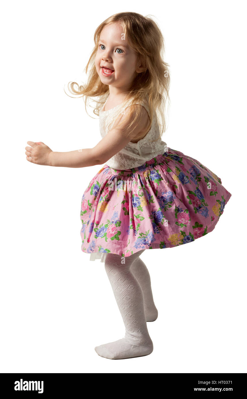 Cute three-year girl is jumping, running, dancing, laughing. Her hair ...