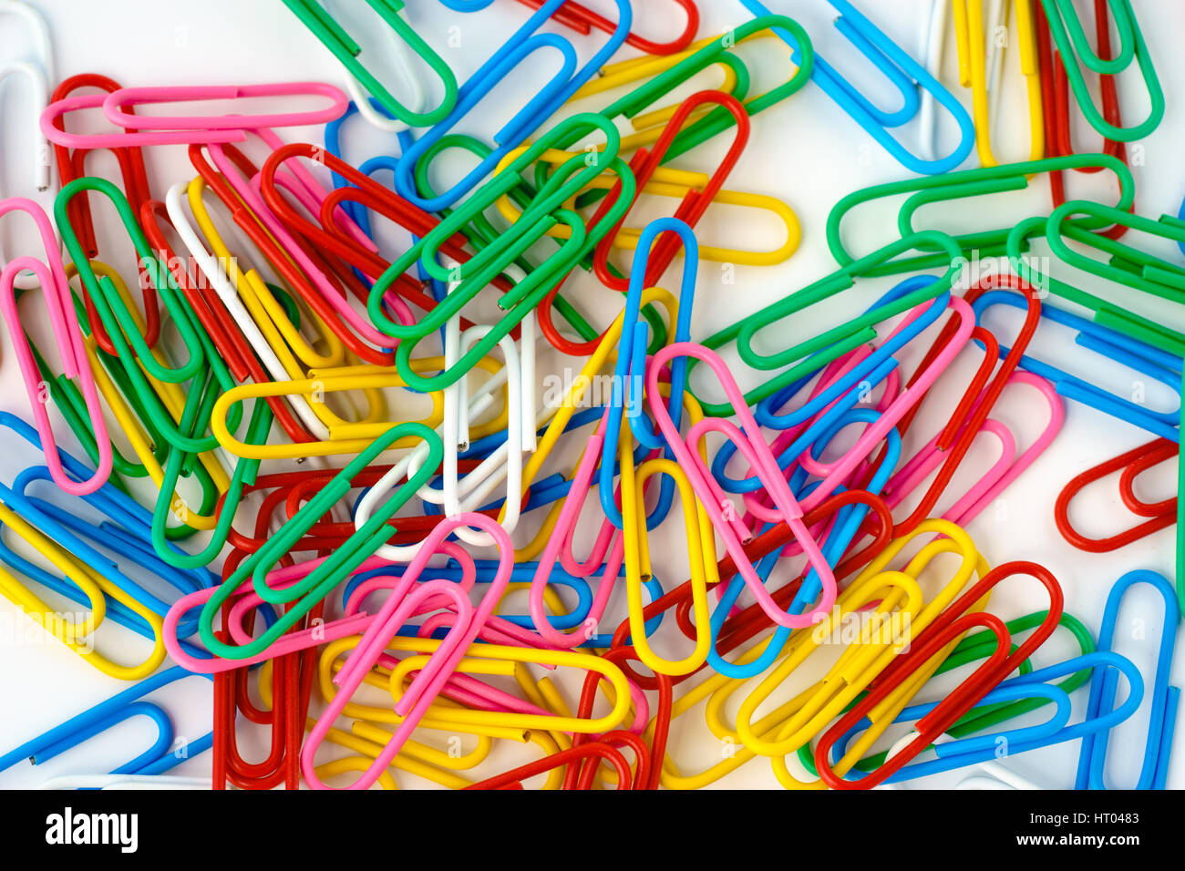 Colorful paperclips on white background Stock Photo - Alamy