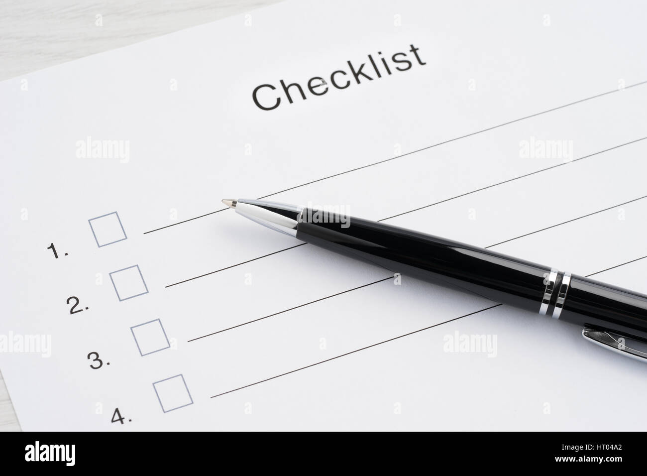 Checklist close-up and pen Stock Photo - Alamy