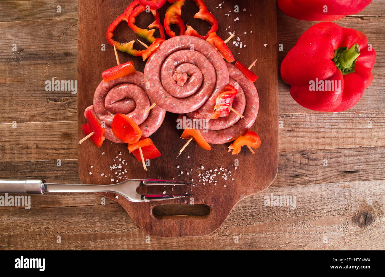 Raw sausage on wooden table Stock Photo - Alamy