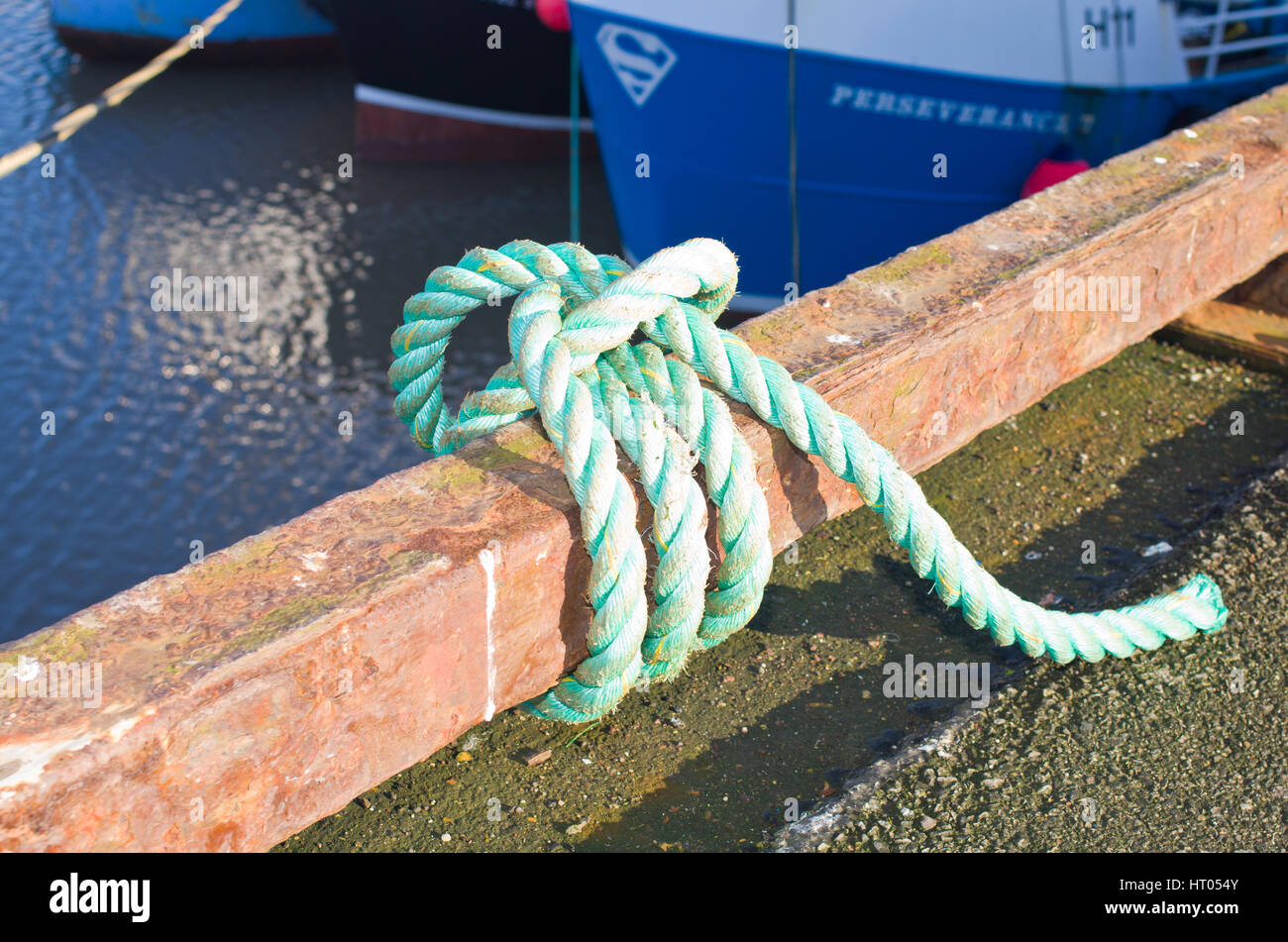 Rope tied to harbour rail Uk Stock Photo - Alamy