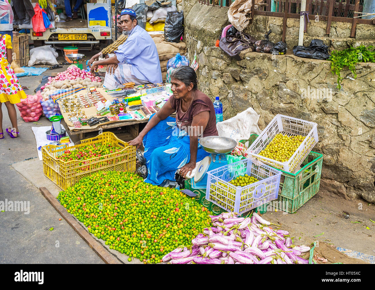 COLOMBO, SRI LANKA - DECEMBER 6, 2016: The aged street trader sits at ...