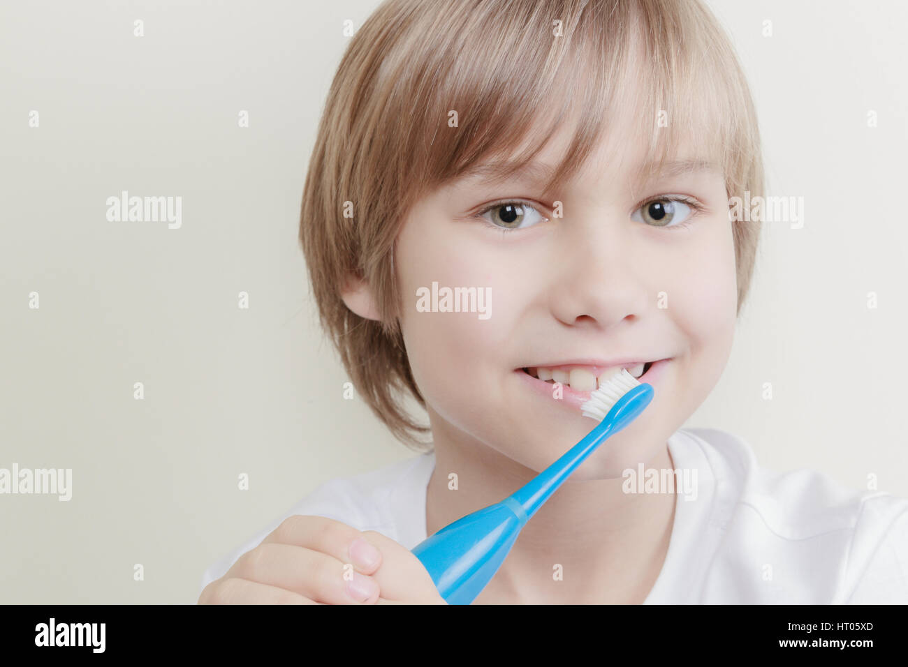 Cute smiling boy brushing his teeth with toothbrush Stock Photo - Alamy
