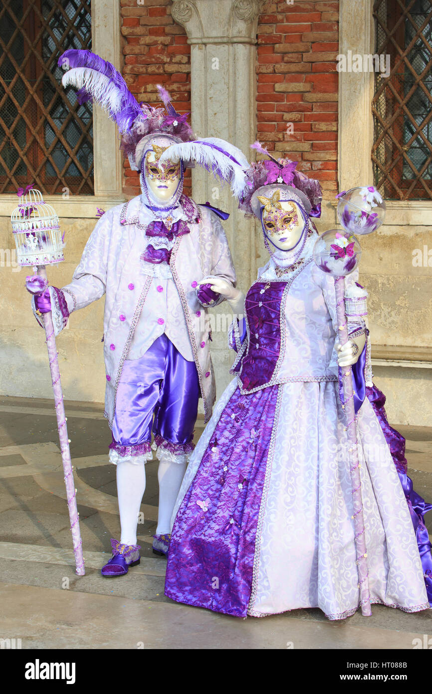 A masked couple in traditional Venetian costumes outside the Doge's ...