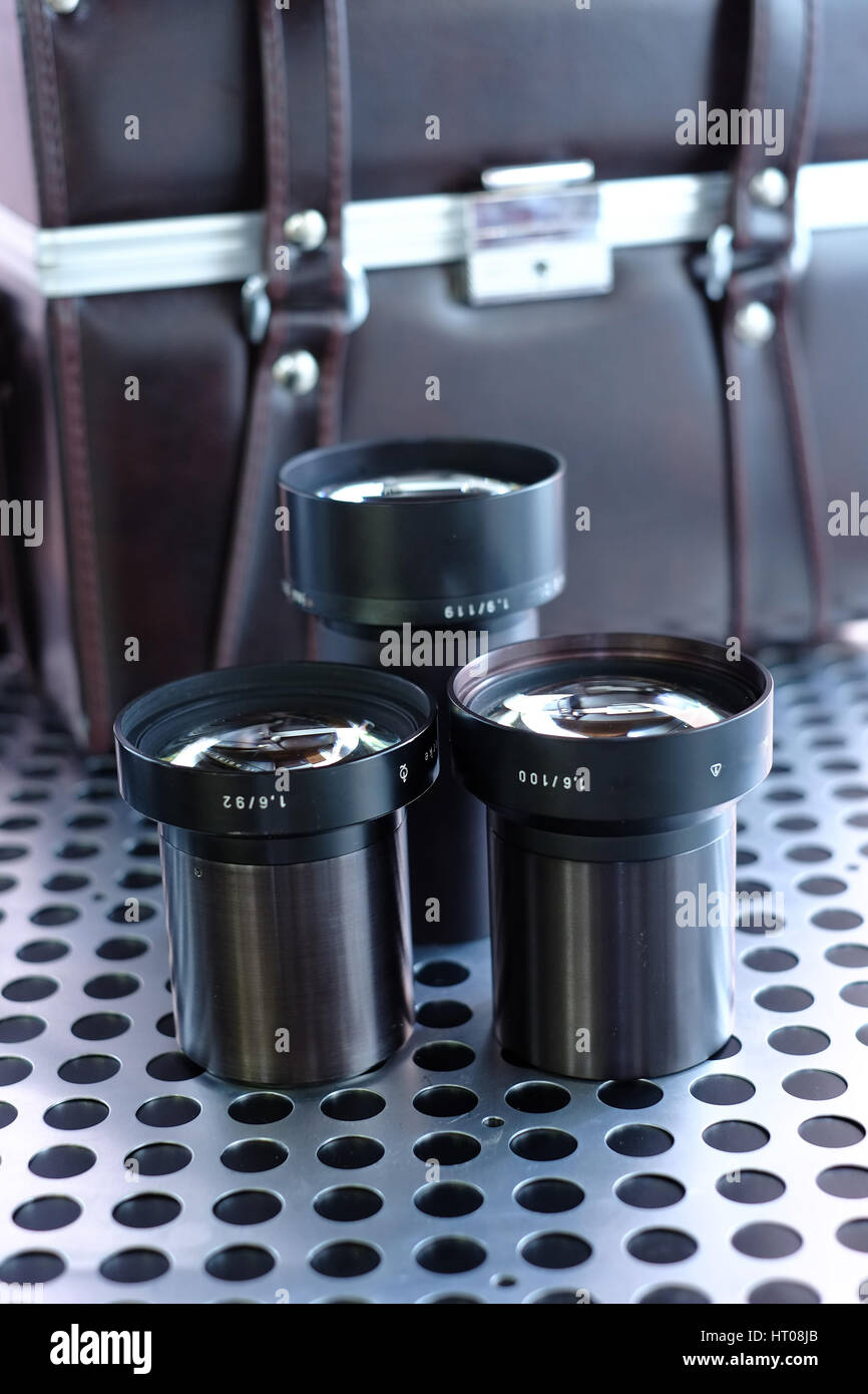 Group of different projector lenses on metalic background with leather ...