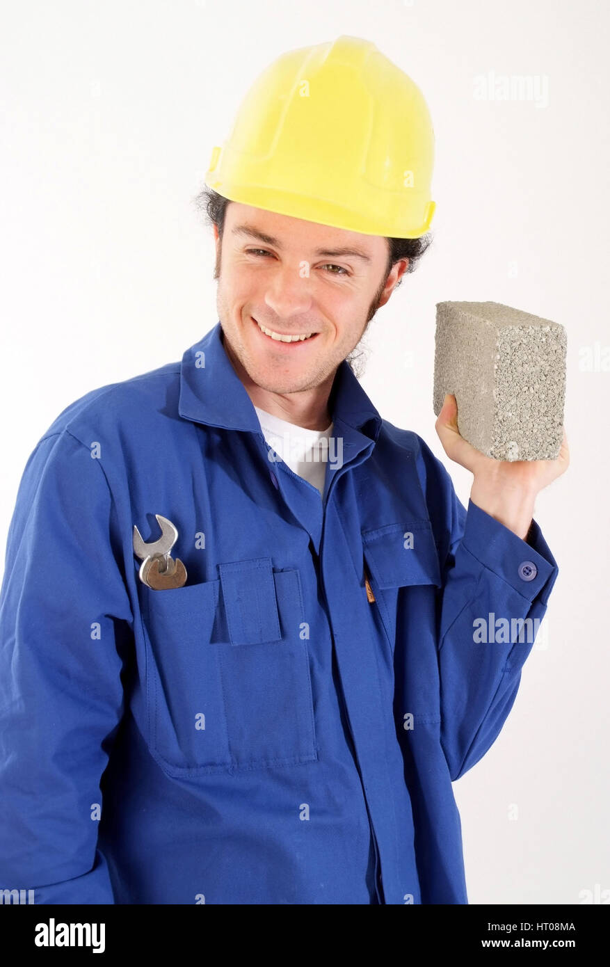 Bauarbeiter mit Blaumann, Bauhelm und Werkzeug - building worker with ...