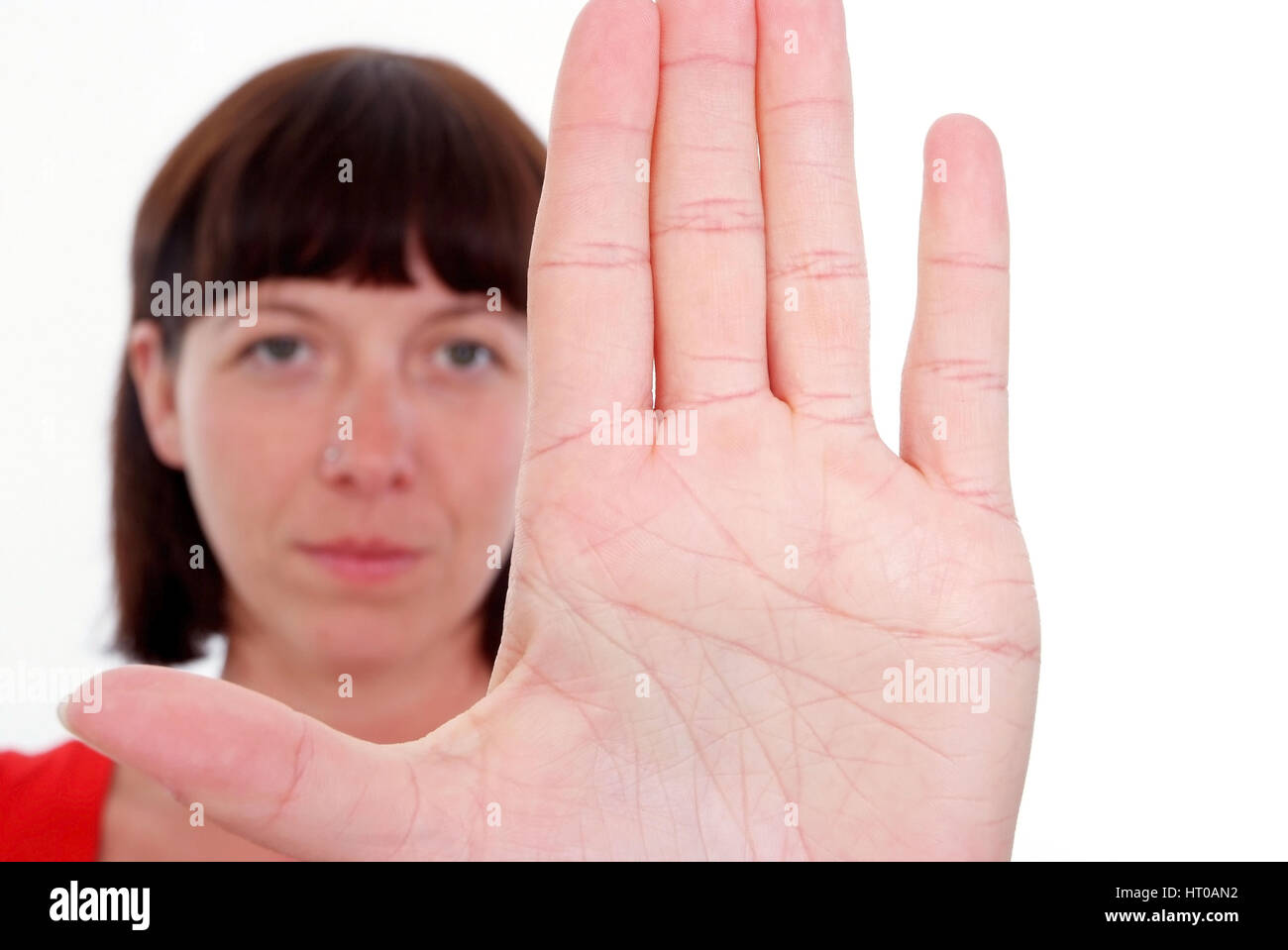Frau mit ausgestreckter Hand, Symbolbild Stop, Abgrenzung - woman with ...