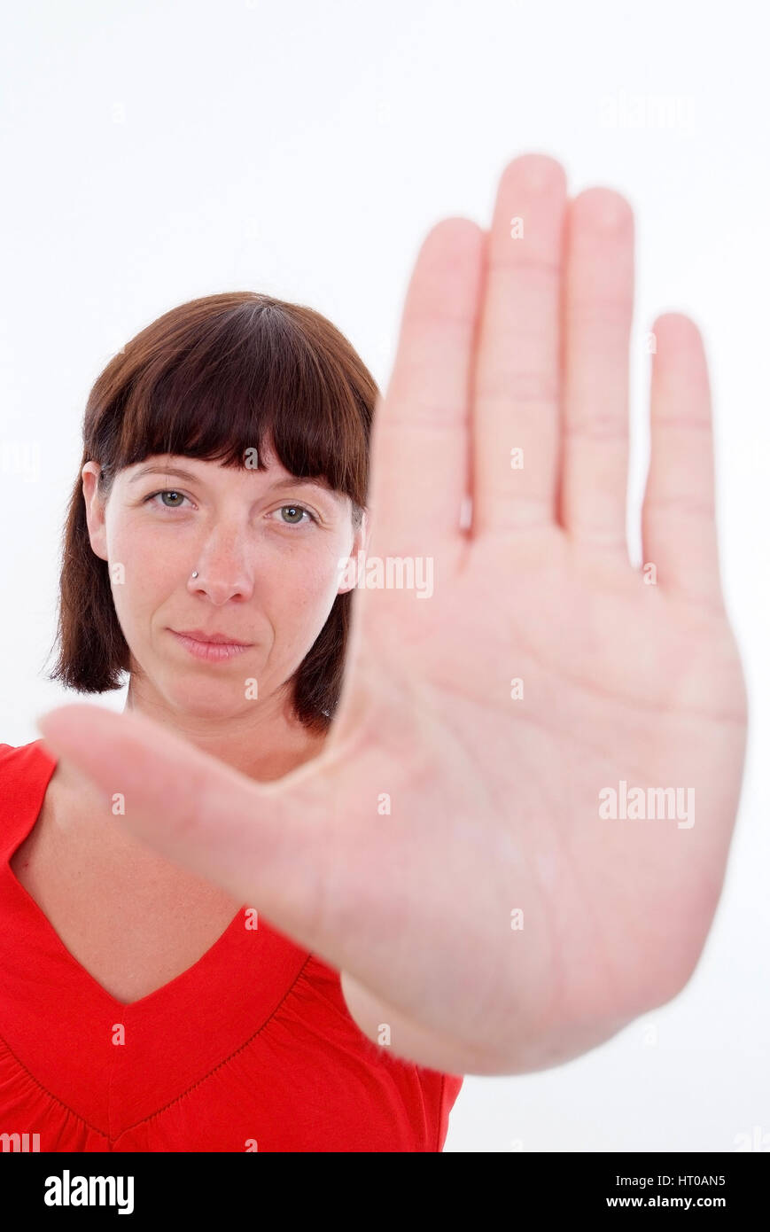 Frau mit ausgestreckter Hand, Symbolbild Stop, Abgrenzung - woman with ...