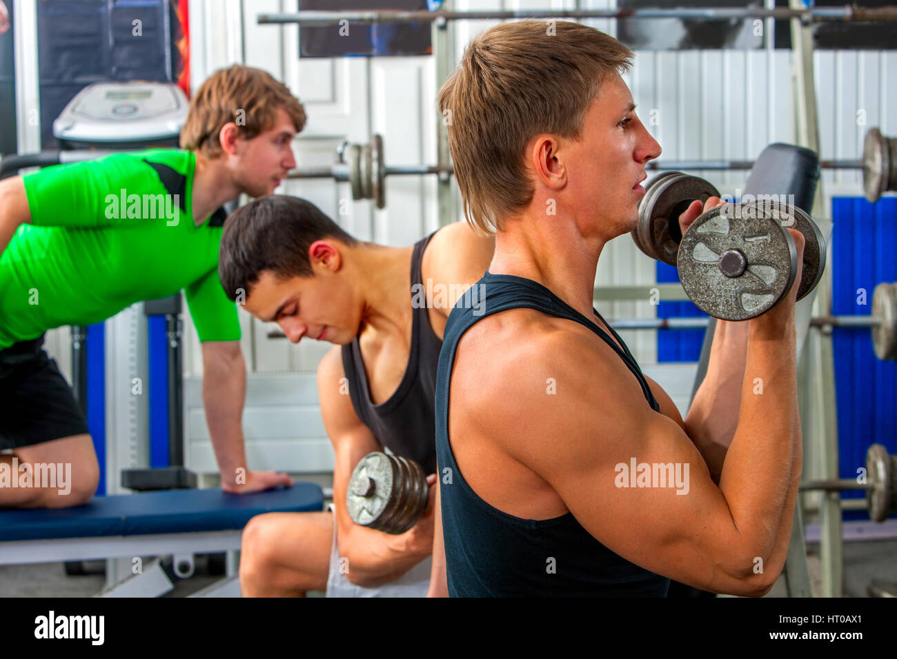 Fitness men friends in gym workout weights with equipment Stock Photo ...