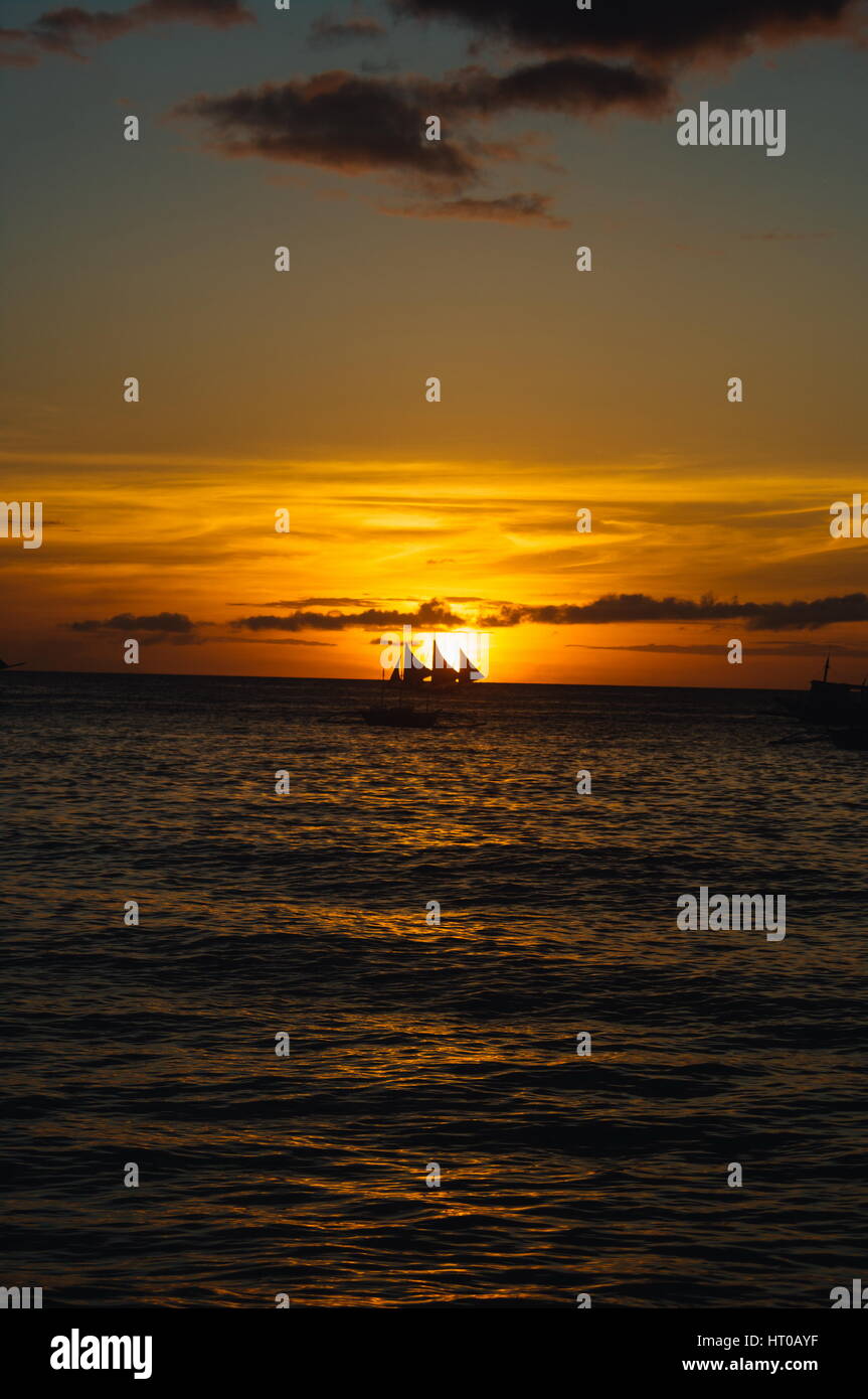 Beautiful golden sunset over fishing boats on the sea Stock Photo - Alamy