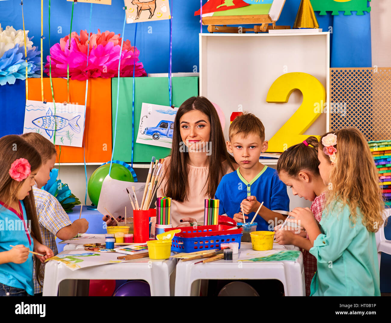 Children painting and drawing together . Craft lesson in primary school ...